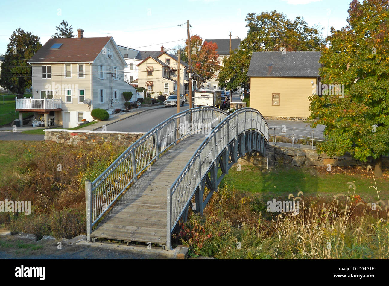 A modern footbridge spans an old canal, known as a race, in the Biery’s ...