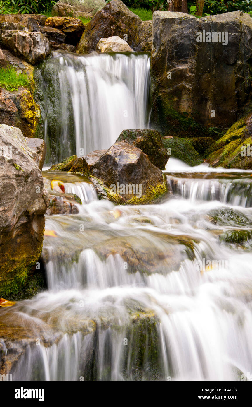 Slow exposure photography of a multi tiered waterfall over rocks ...