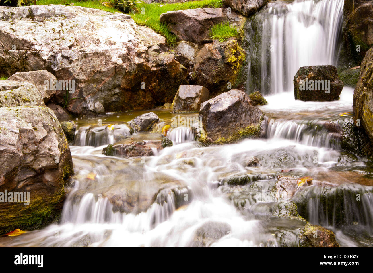 Slow exposure photography of a multi tiered waterfall over rocks ...