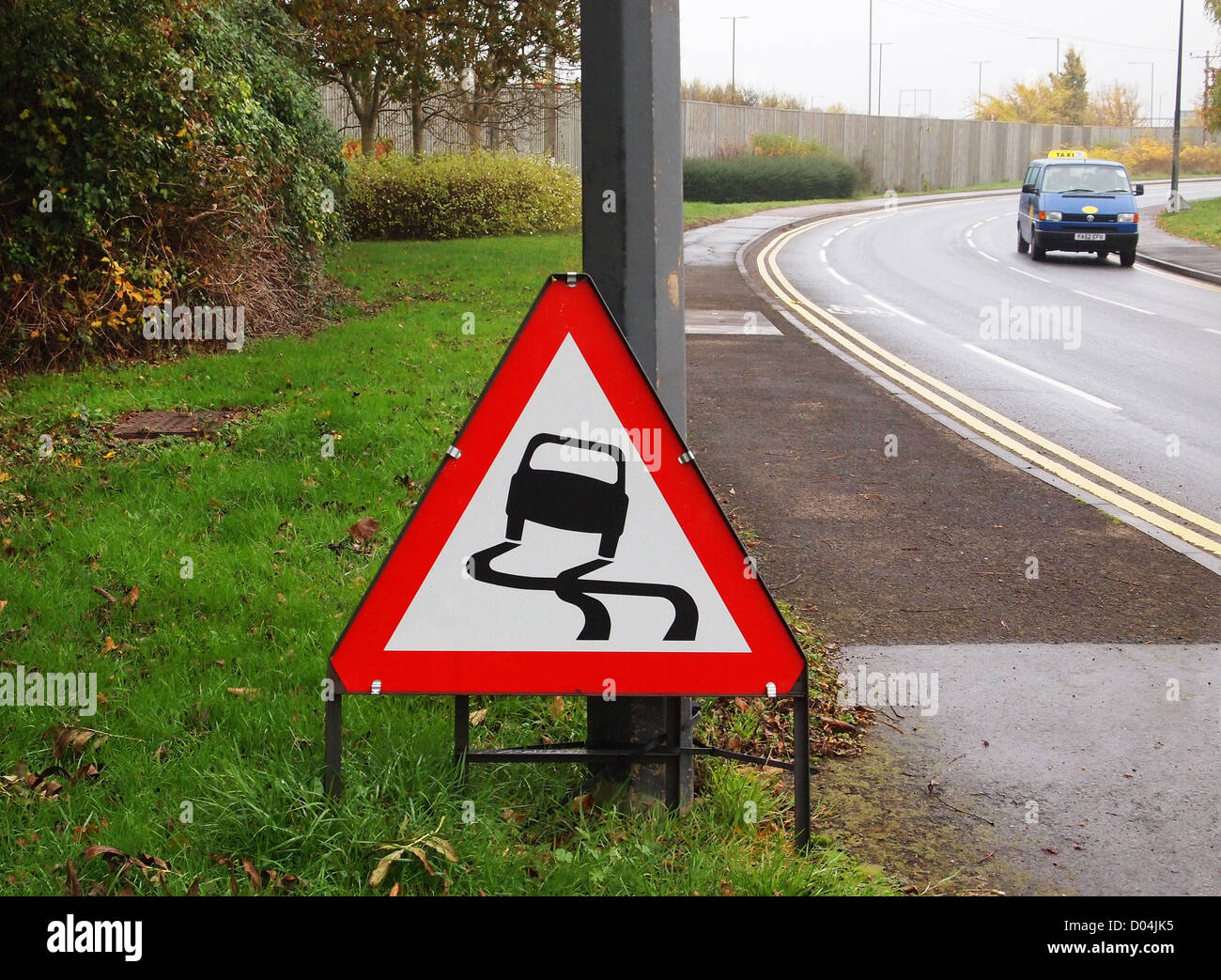 Slippery road ahead sign Stock Photo - Alamy