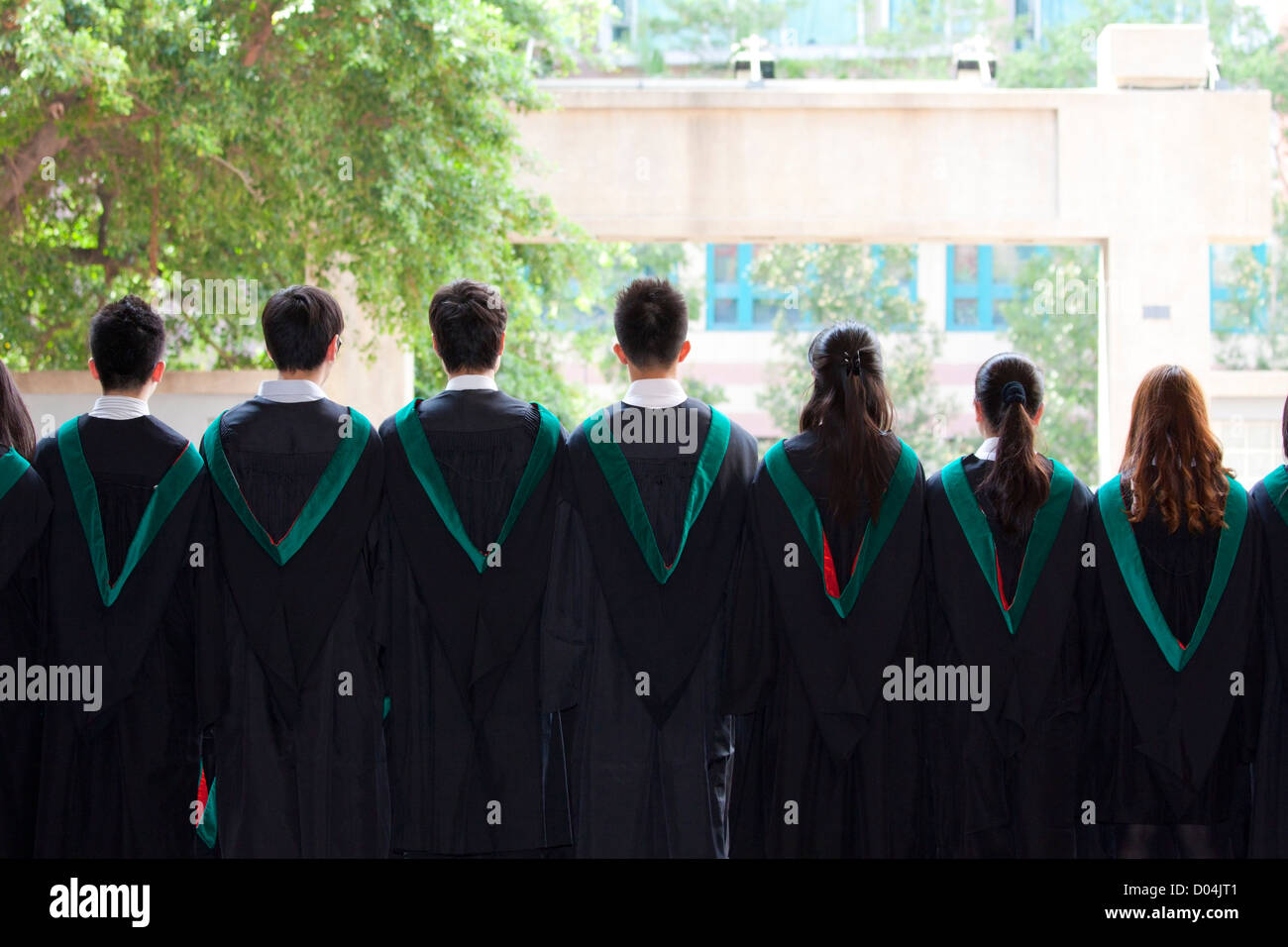 Back of university graduates with their gowns Stock Photo - Alamy