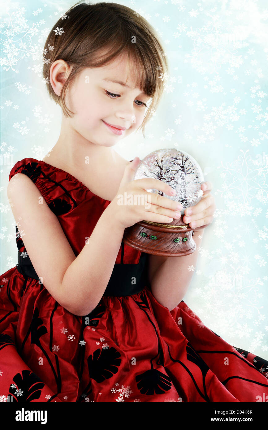 Happy little girl holding a snow globe Stock Photo - Alamy