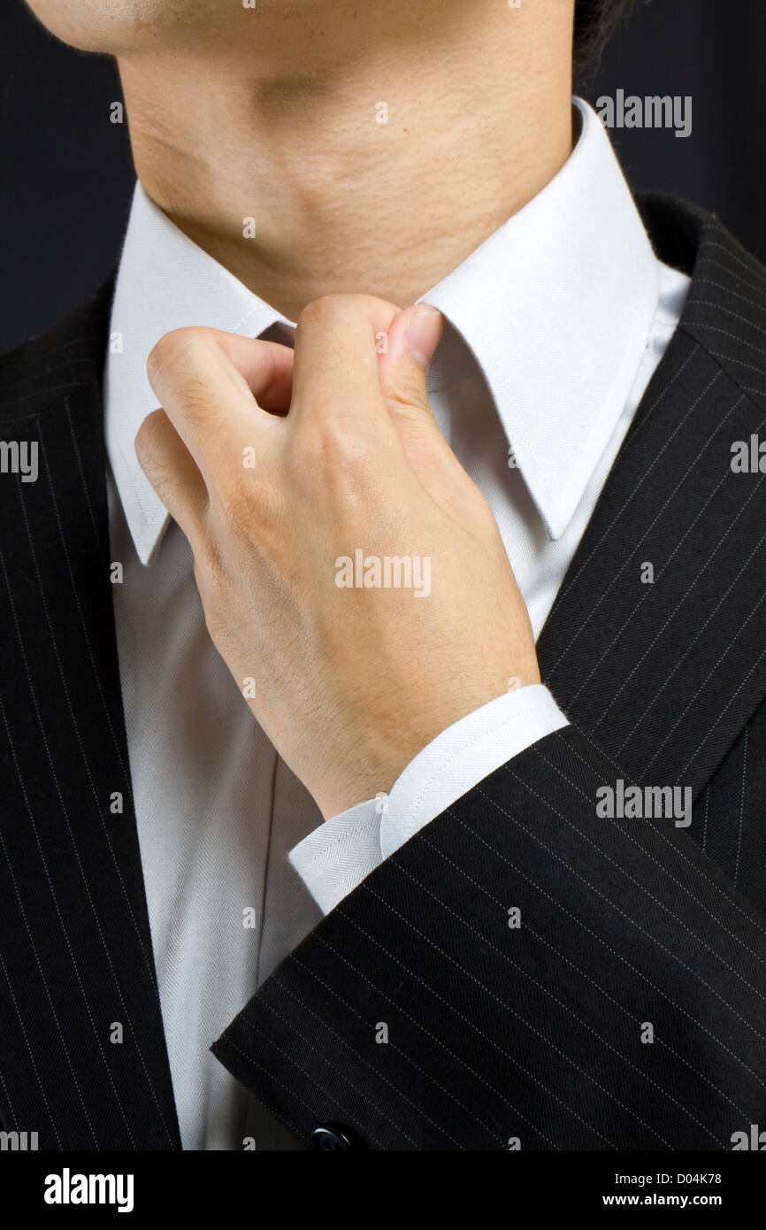 Business man adjusting his suit Stock Photo - Alamy
