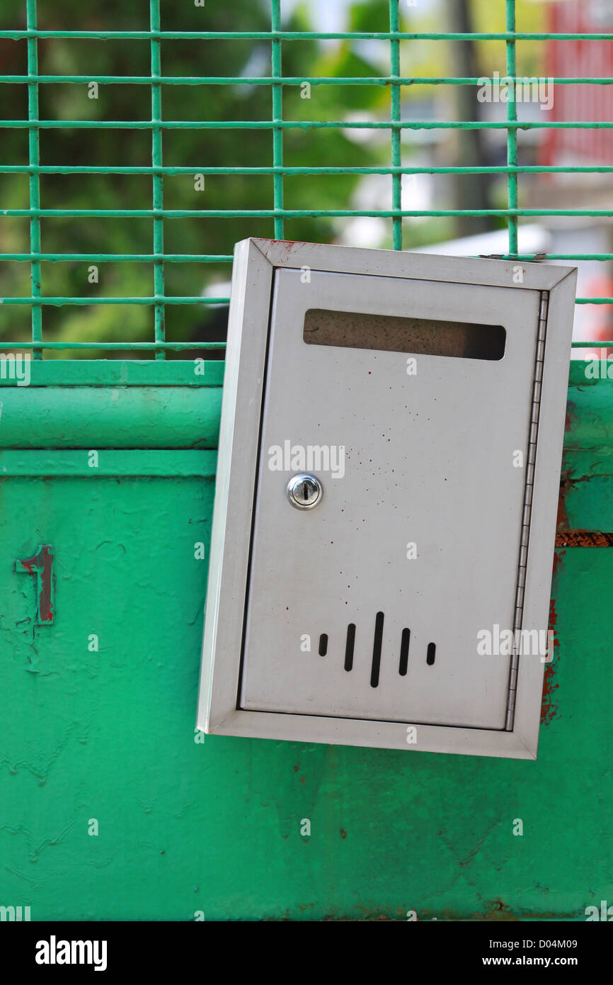 Postbox on door gate Stock Photo - Alamy