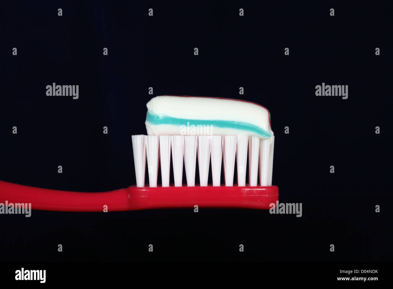 A red toothbrush on a blue background, with a striped toothpaste Stock ...