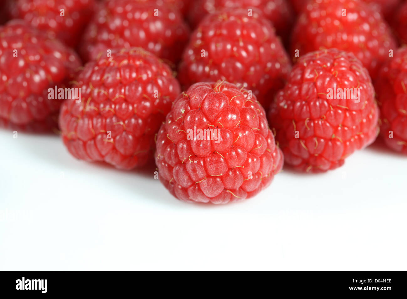 Multiple raspberries on a white background Stock Photo - Alamy
