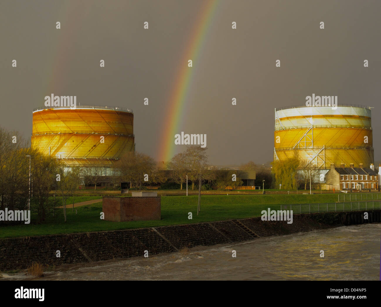 A rainbow against a dark threatening sky between gasometers Exeter ...