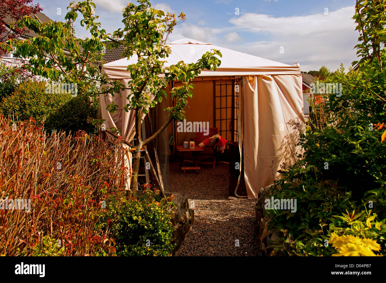 A garden tent, party tent in a summer garden Stock Photo - Alamy