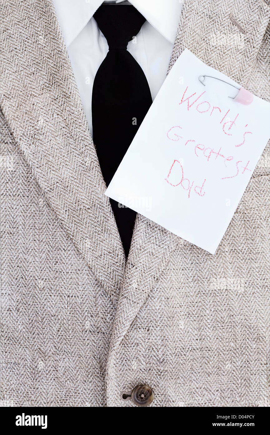 Man's suit jacket, tie and shirt with World's Greatest Dad note pinned ...