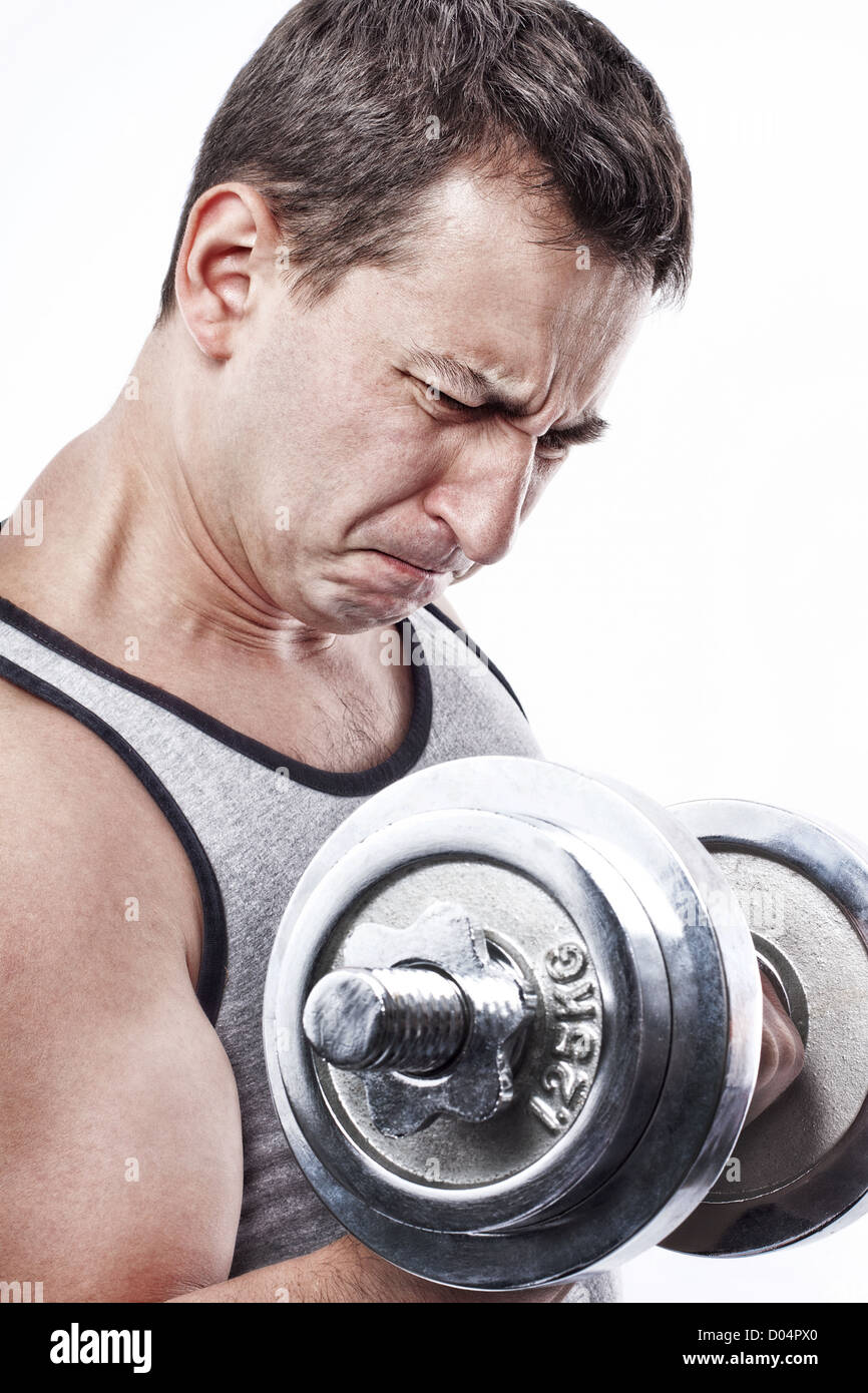 Young man doing weights lifting force Stock Photo - Alamy