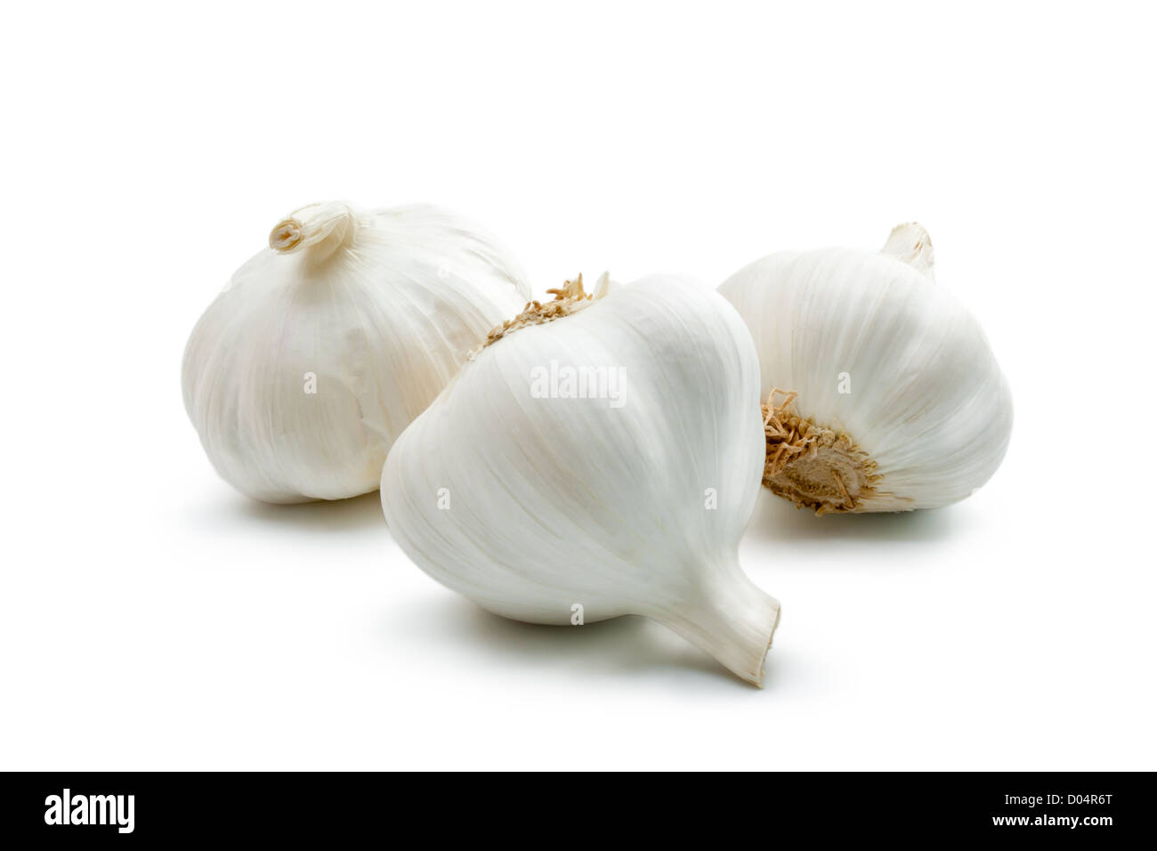 Three cloves of garlic arranged on a white background close-up Stock ...
