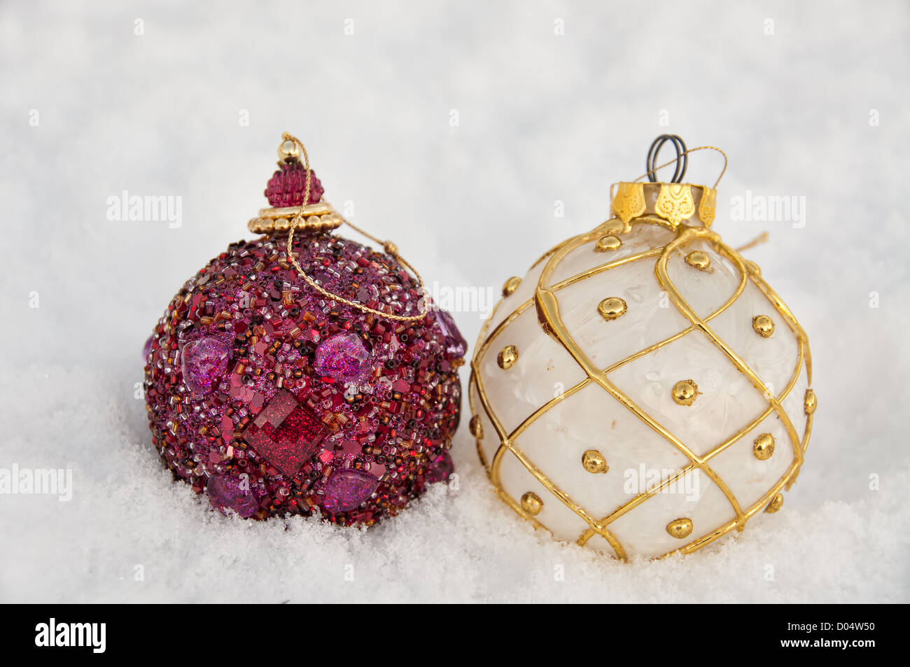 Two christmas bulbs in the snow. Isolated Stock Photo - Alamy