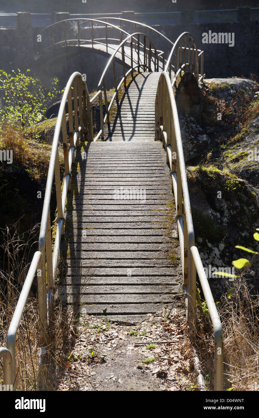 Curved footbridge over rocks, Limousin, France Stock Photo - Alamy