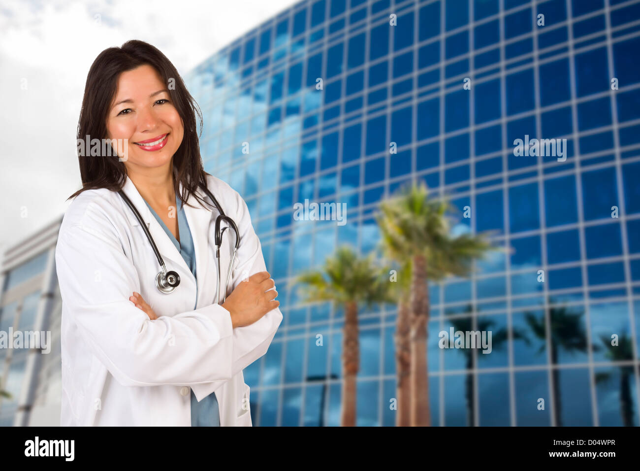 Attractive Hispanic Doctor or Nurse in Front of Corporate Building ...