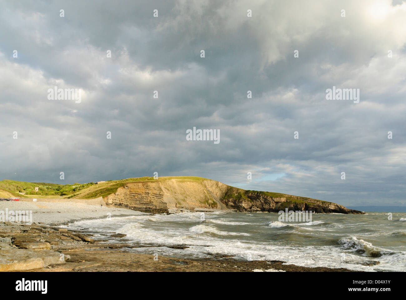 Wave-cut platform, beach and Cliffs under a dramatic sky at ...