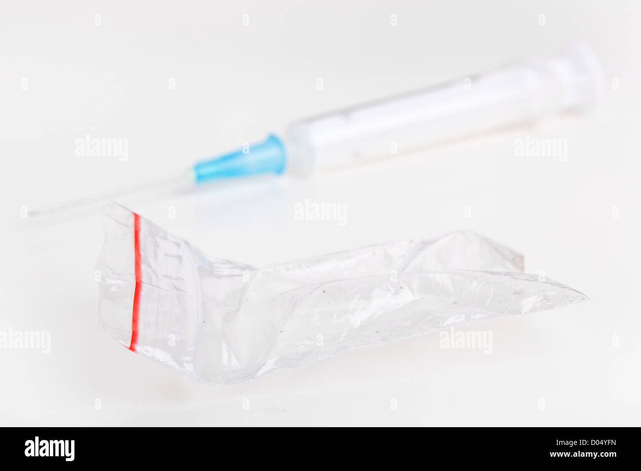 Syringe and pocket closeup on white background Stock Photo - Alamy