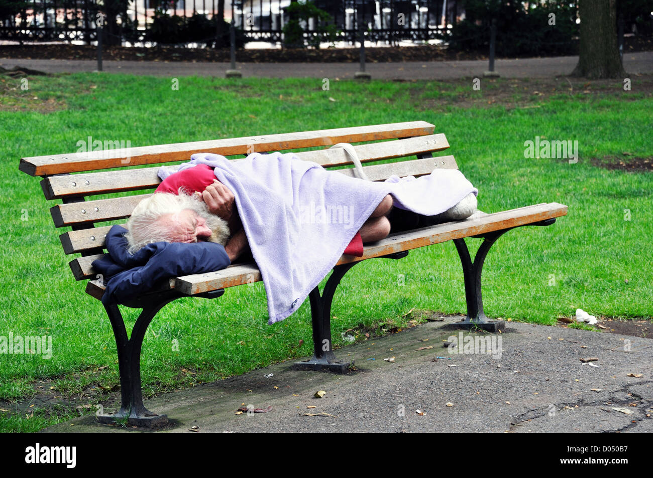 Homeless man sleeping in park Stock Photo - Alamy