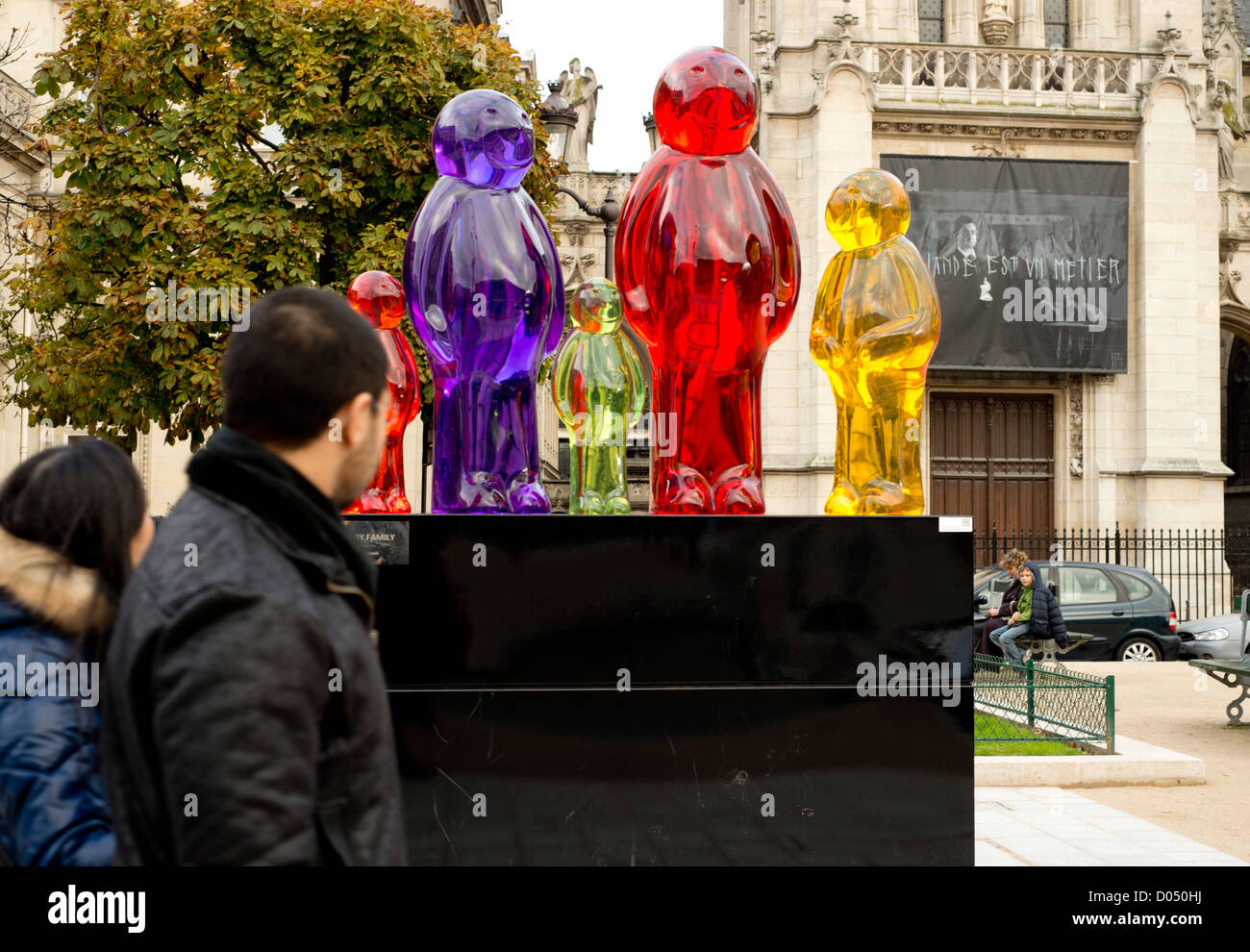 Colored glass sculpture of strange people in Paris with tow young ...