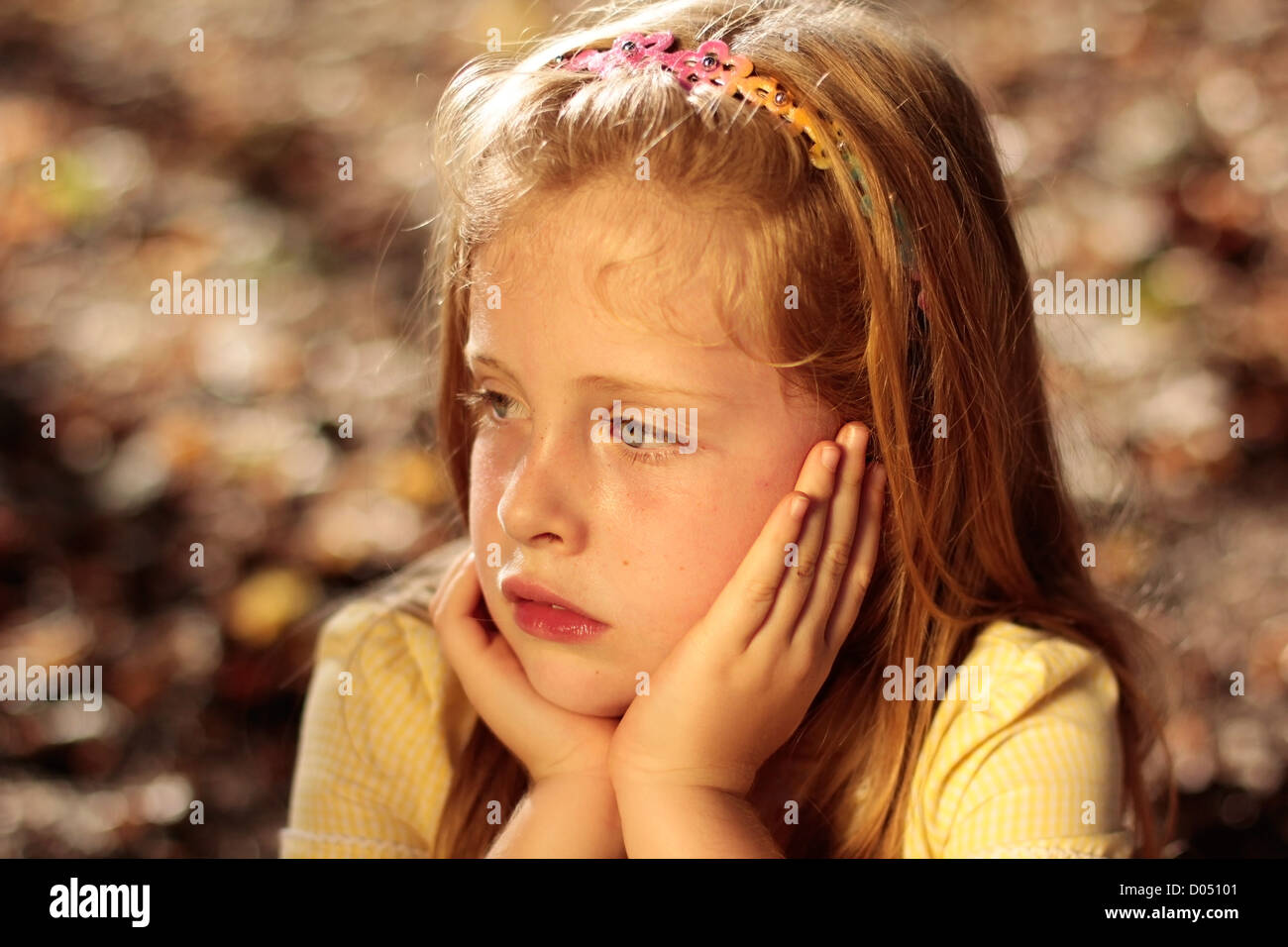 Young girl looking fed up and bored Stock Photo - Alamy