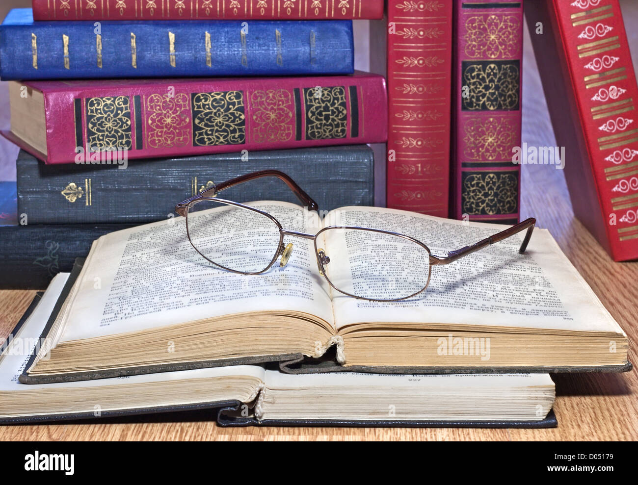 Vintage books with glasses on wooden table Stock Photo - Alamy
