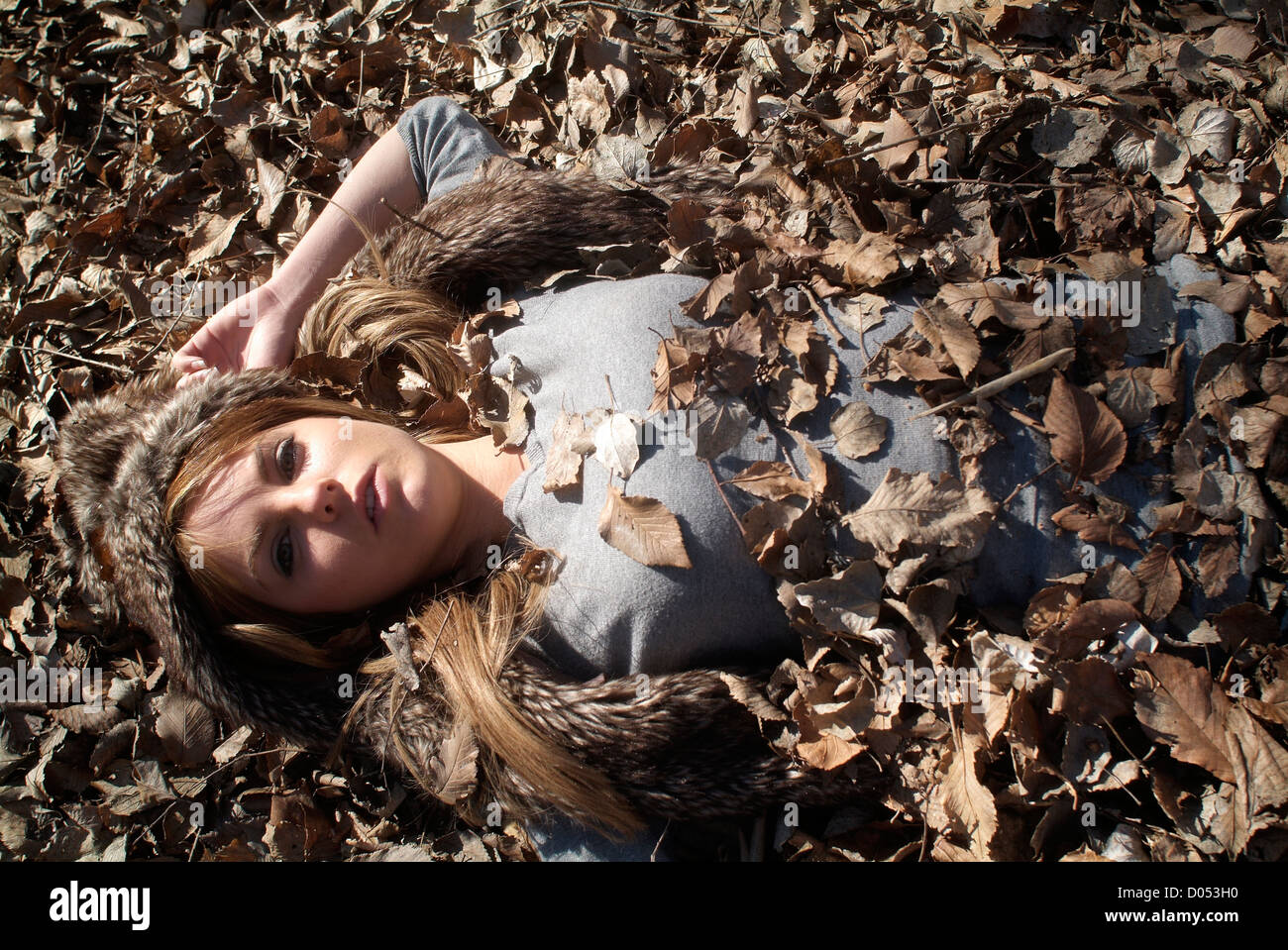 Woman buried in oak leafs Stock Photo - Alamy