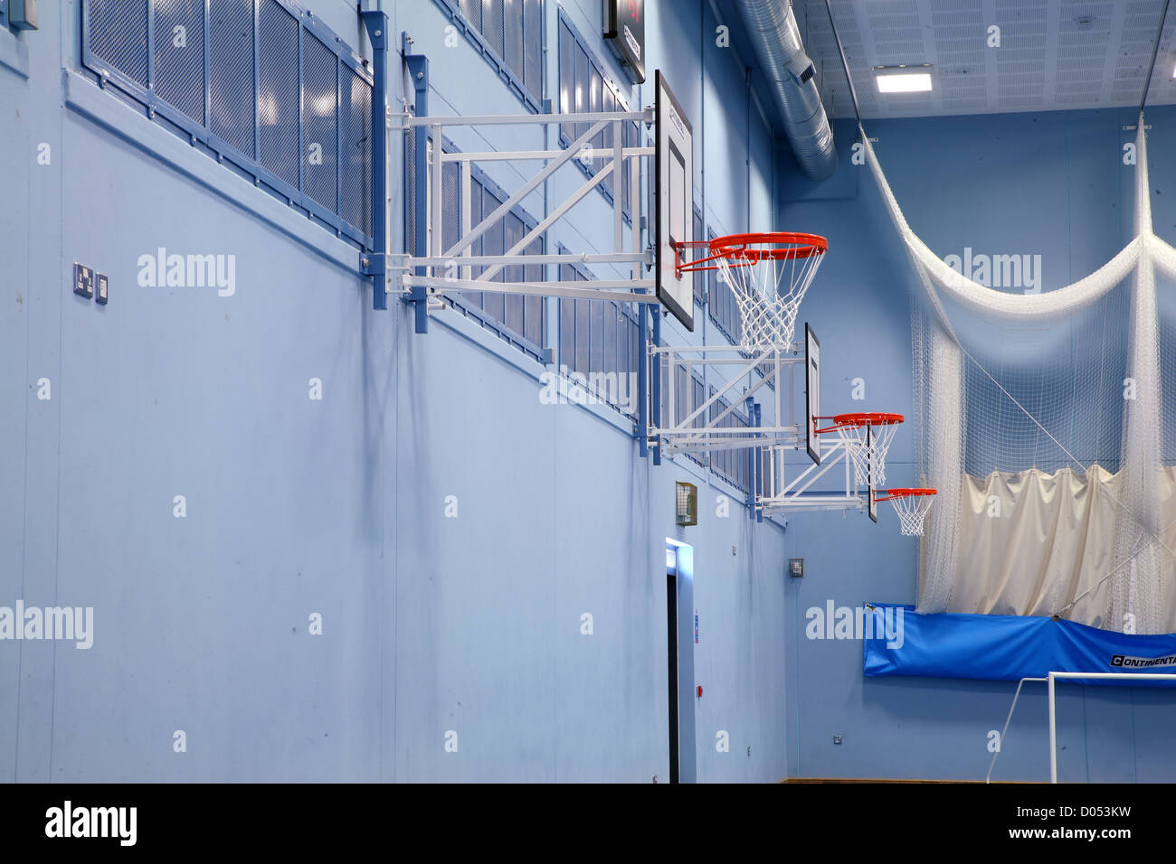 Blue school gym, with basket ball hoops and nets, October 2008 Stock ...