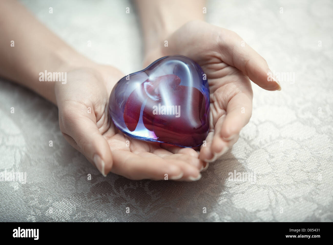 Woman hands holding heart shape object Stock Photo - Alamy
