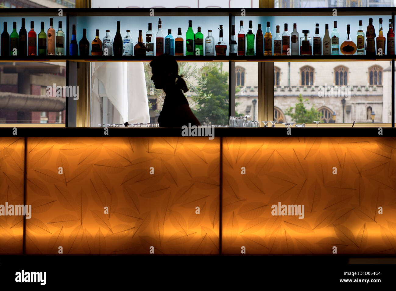Woman works behind the desk of bar in barbican centre hi-res stock ...