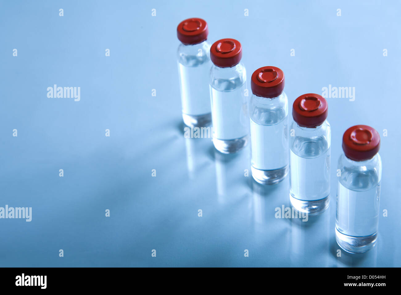 Vials with liquid for medicine or science, blue toned image, selective ...