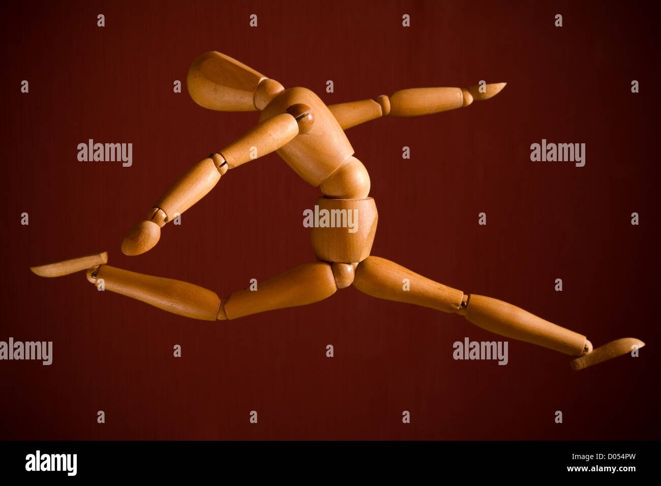 Flying wooden puppet over red background Stock Photo - Alamy