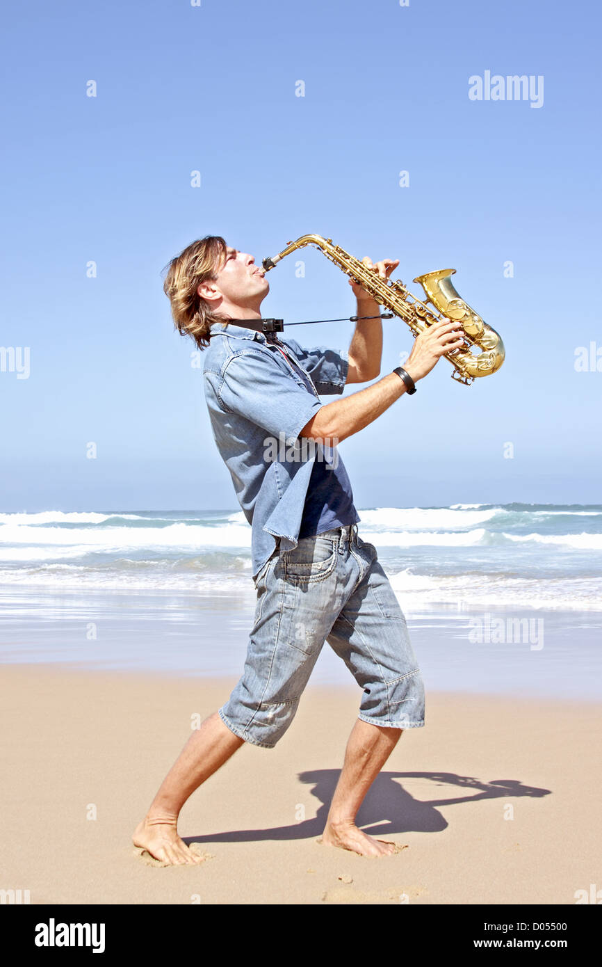 Saxophone player at the beach Stock Photo - Alamy