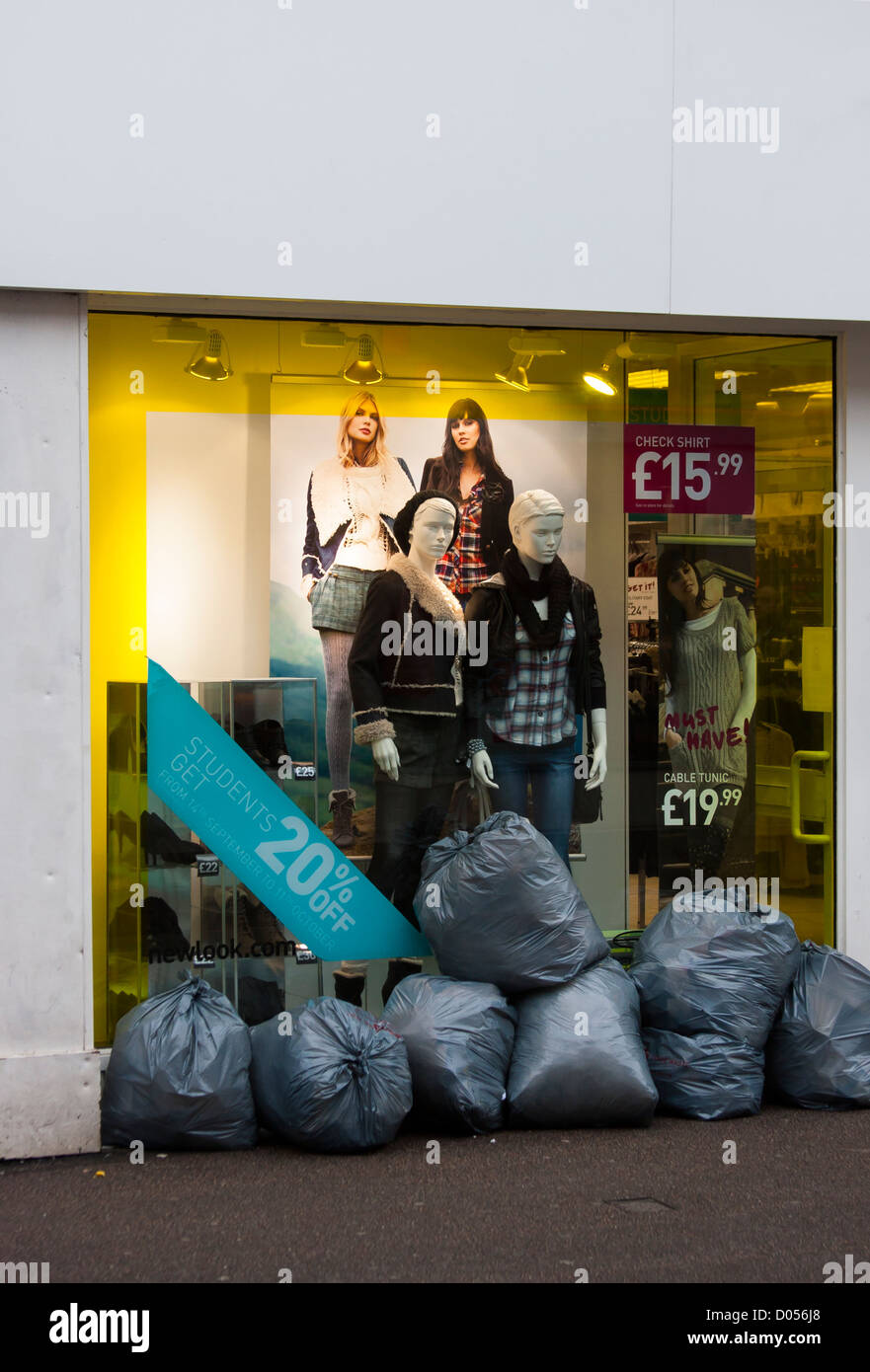 store front with uncollected trash bags Stock Photo - Alamy