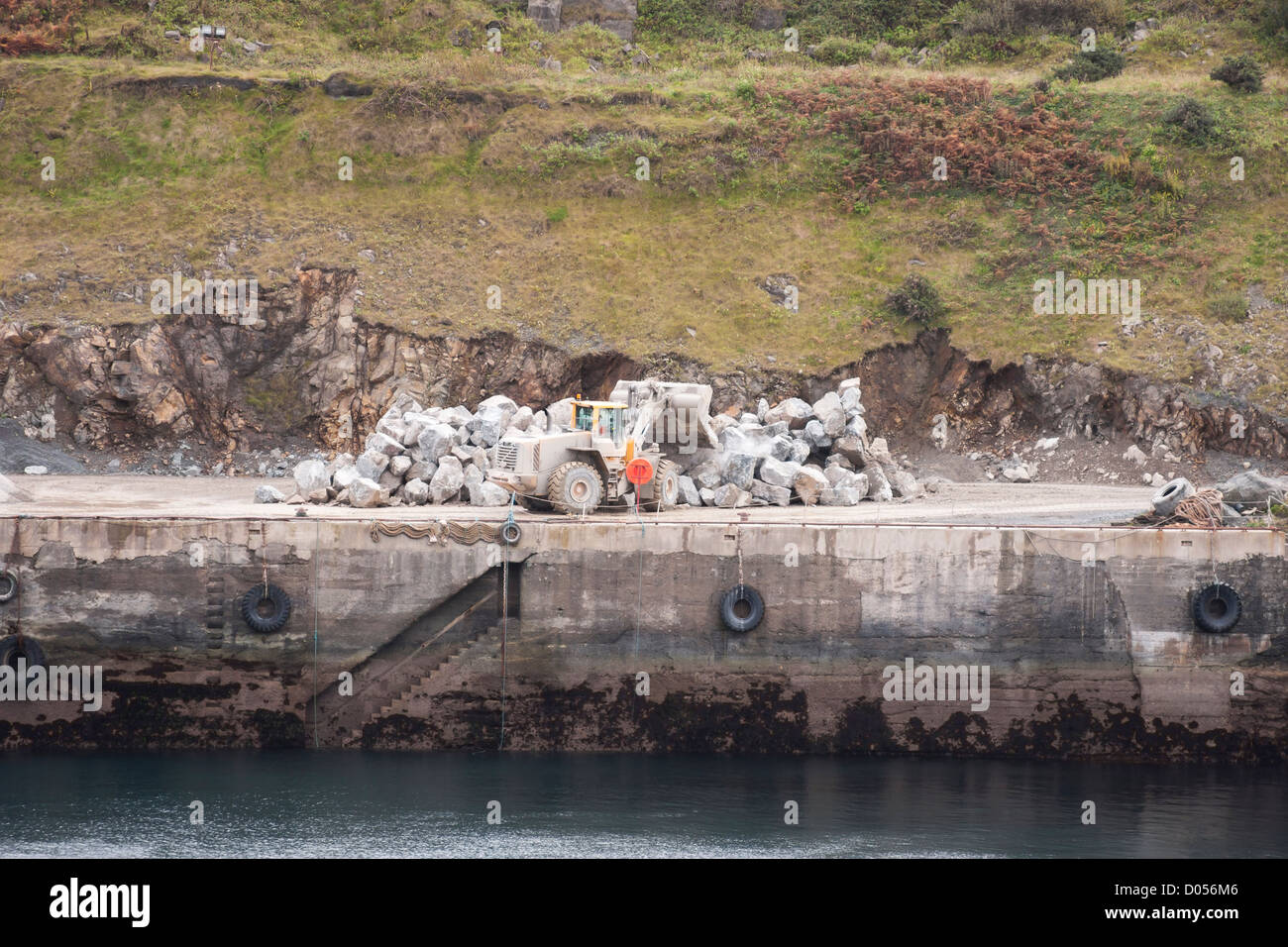 powerful digger loader moving rocks at quayside Stock Photo - Alamy