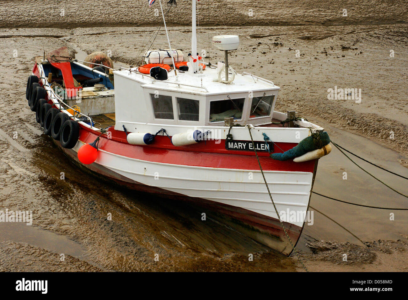 Traditional fishing boat or coble dried out in Bridlington Harbour East ...