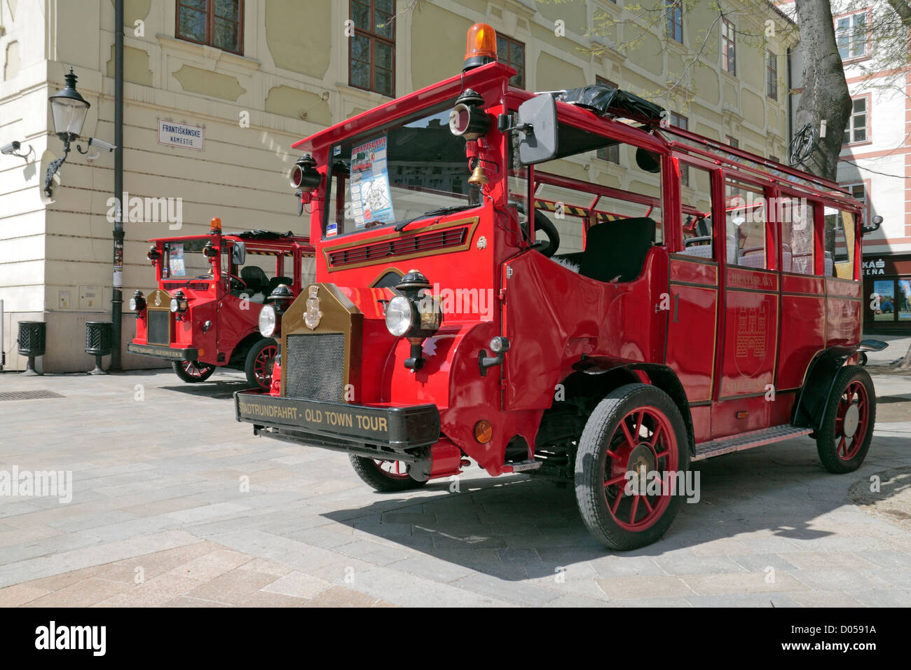 A bright red tourist bus (stadtrundfahrt or "city tour") in Bratislava ...