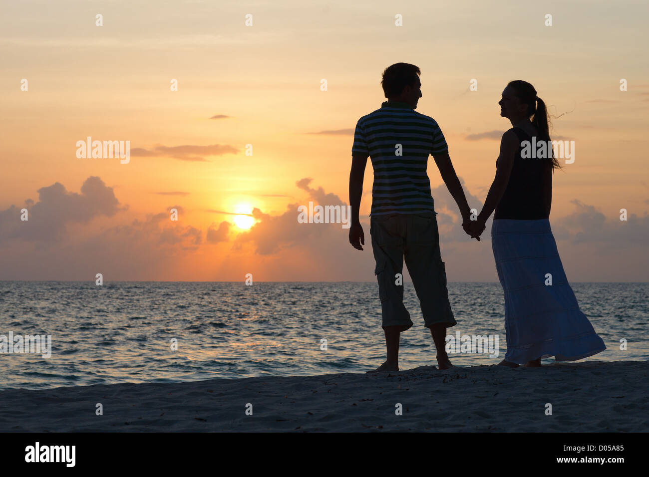 Romantic couple at sunset Stock Photo - Alamy