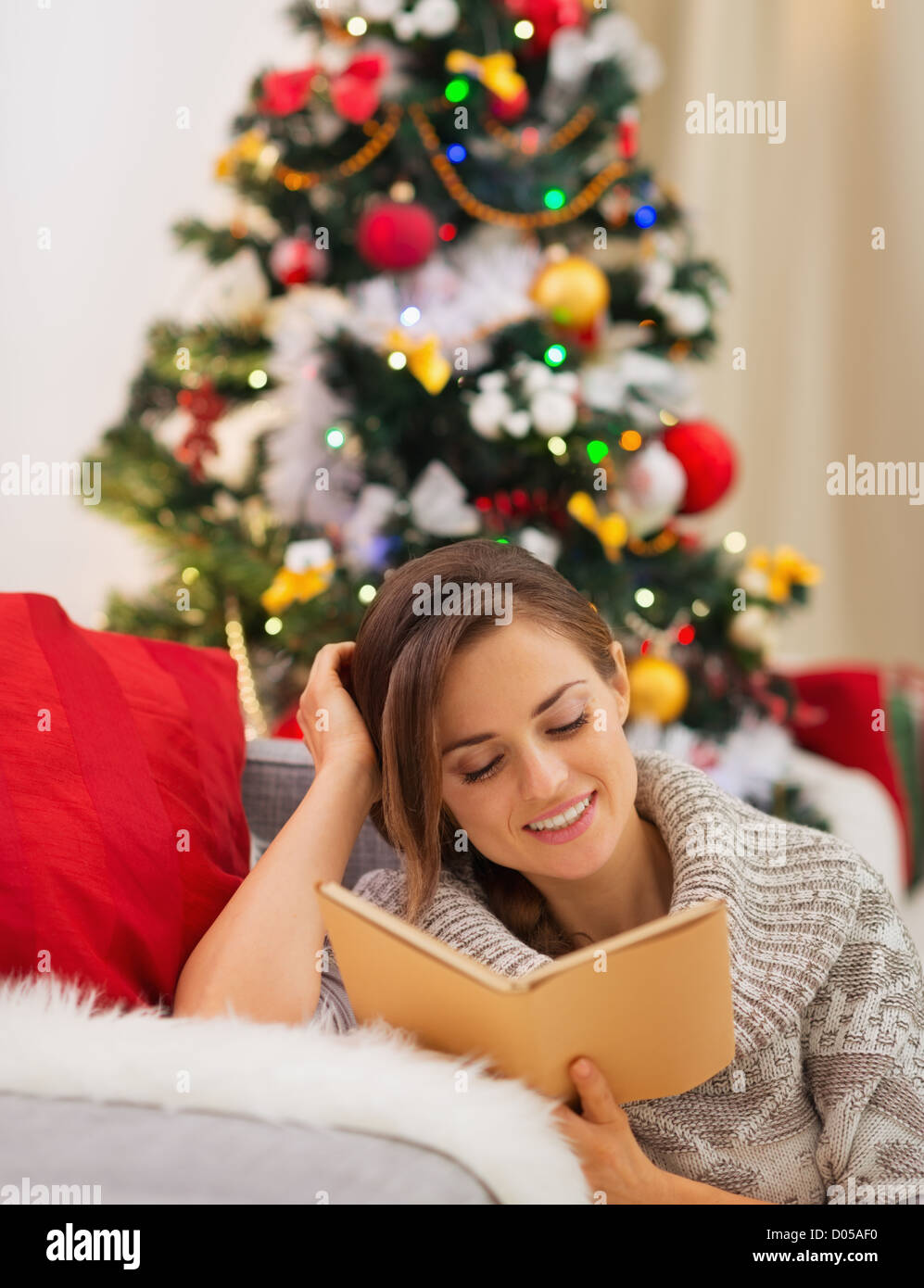 Adult reading near christmas tree hi-res stock photography and images ...