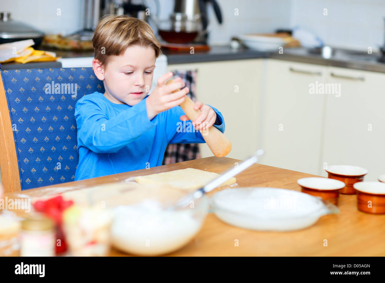 Boy helping at kitchen Stock Photo - Alamy
