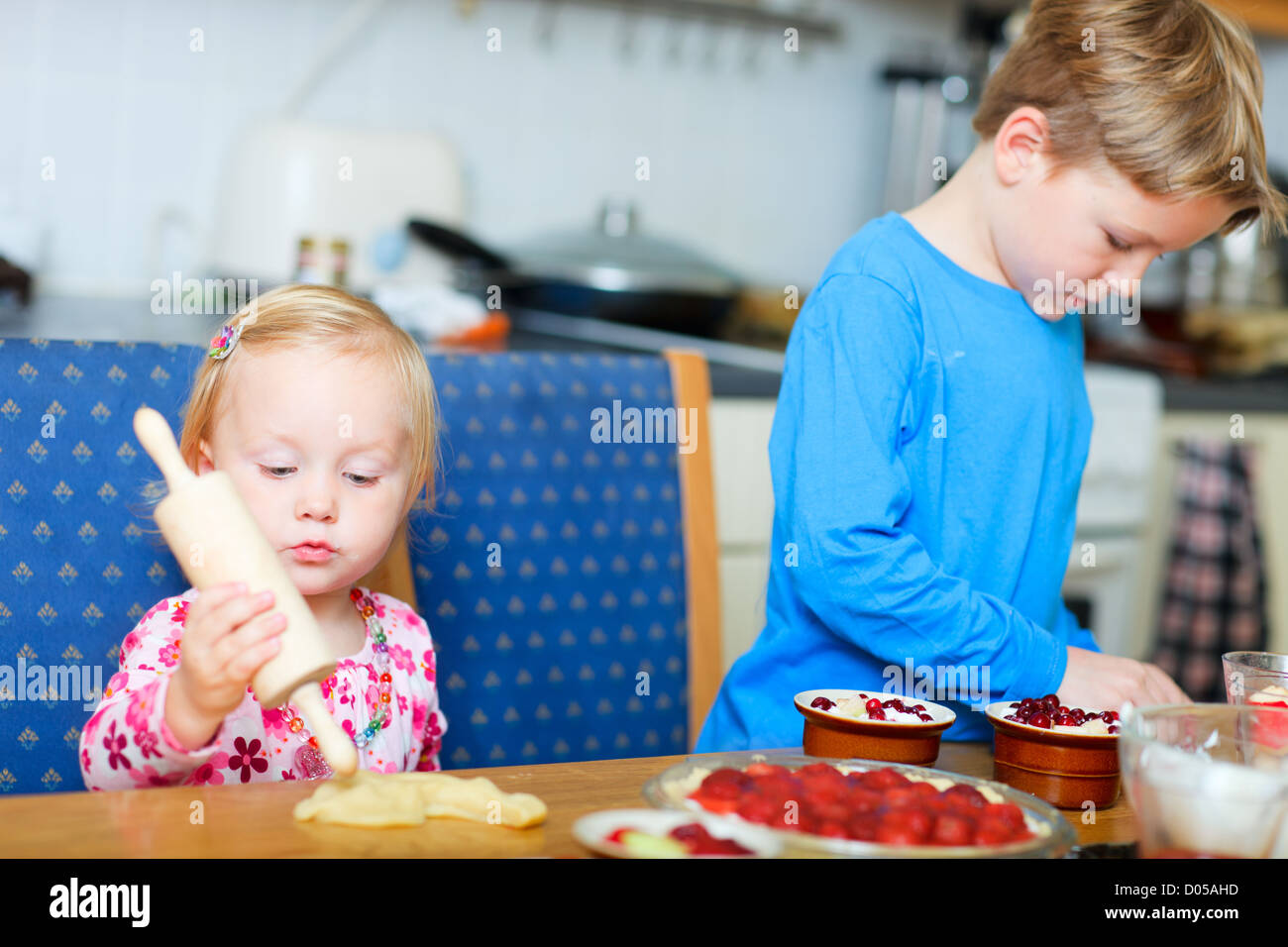Two kids helping to bake pie Stock Photo - Alamy