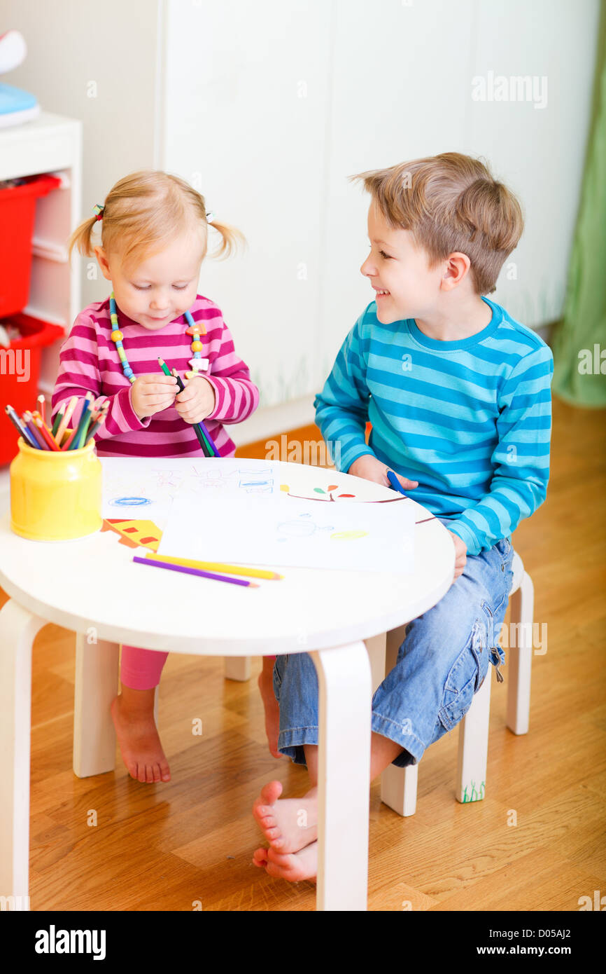 Two kids drawing together Stock Photo - Alamy