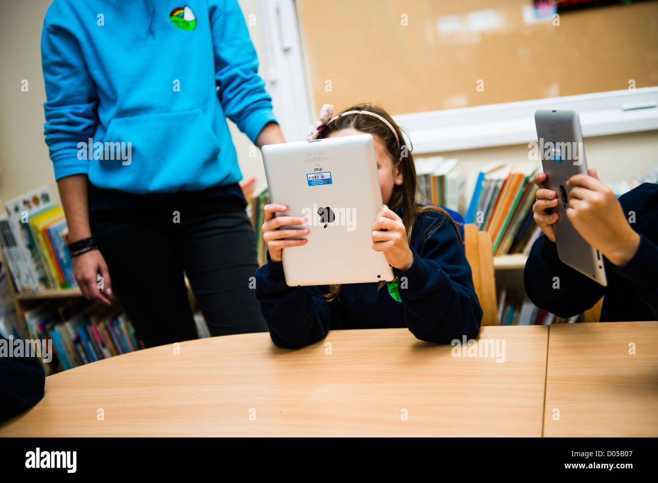 Children using Apple iPad tablet computers at a new community primary ...