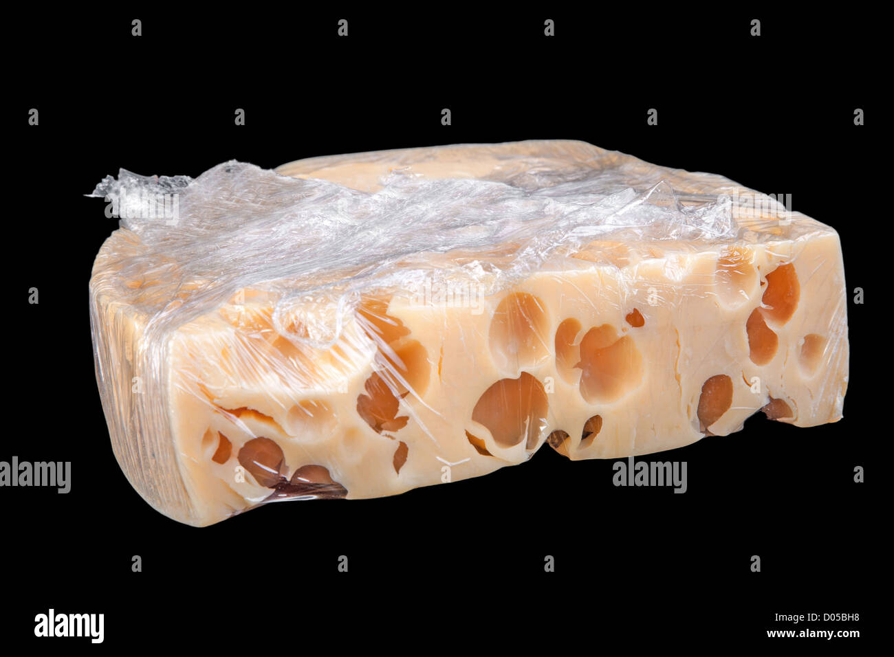 Packed cheese slice isolated on black background Stock Photo - Alamy