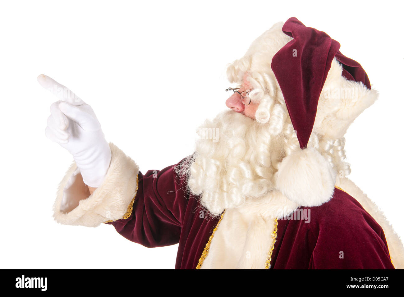 Santa Claus is pointing upwards to something isolated over white ...