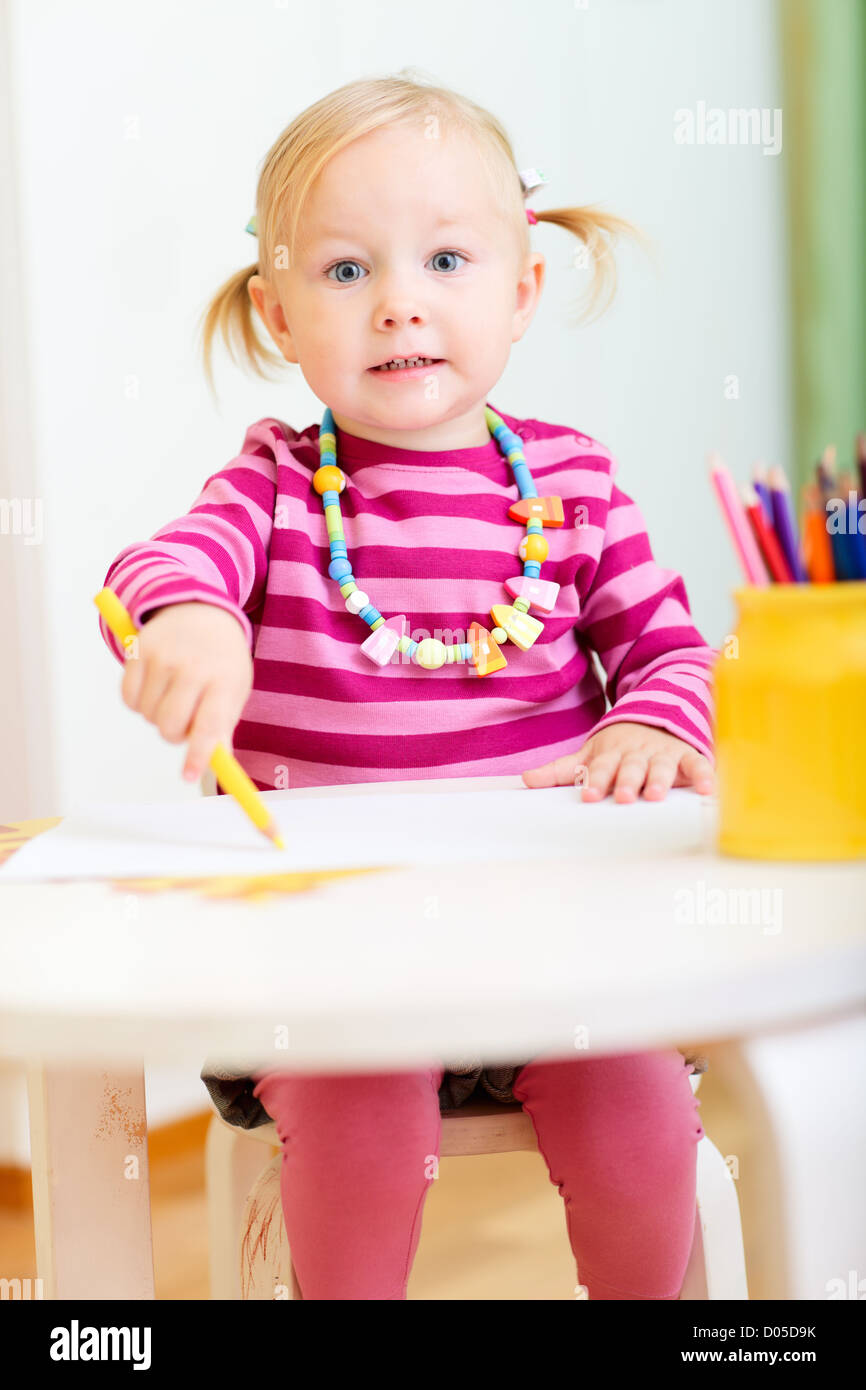 Toddler girl drawing with pencils Stock Photo - Alamy