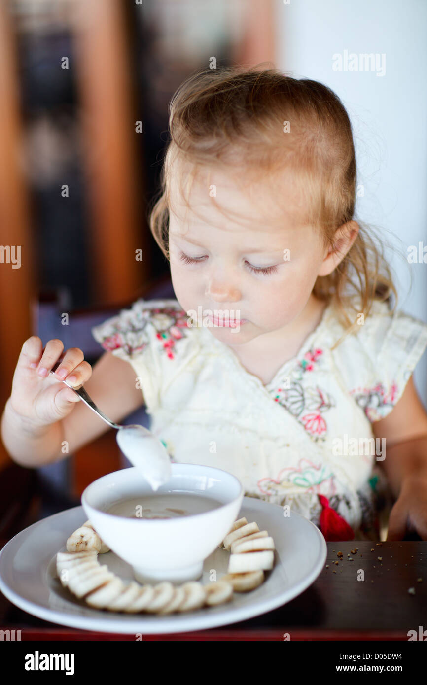 Girl eating breakfast Stock Photo - Alamy