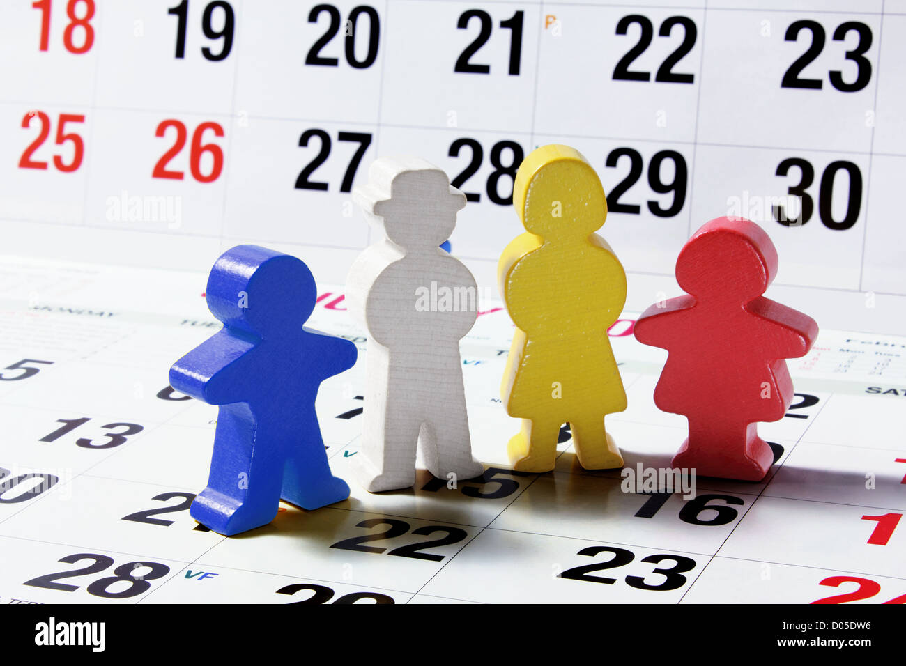 Wooden Miniature Figures on Calendar Page Stock Photo - Alamy