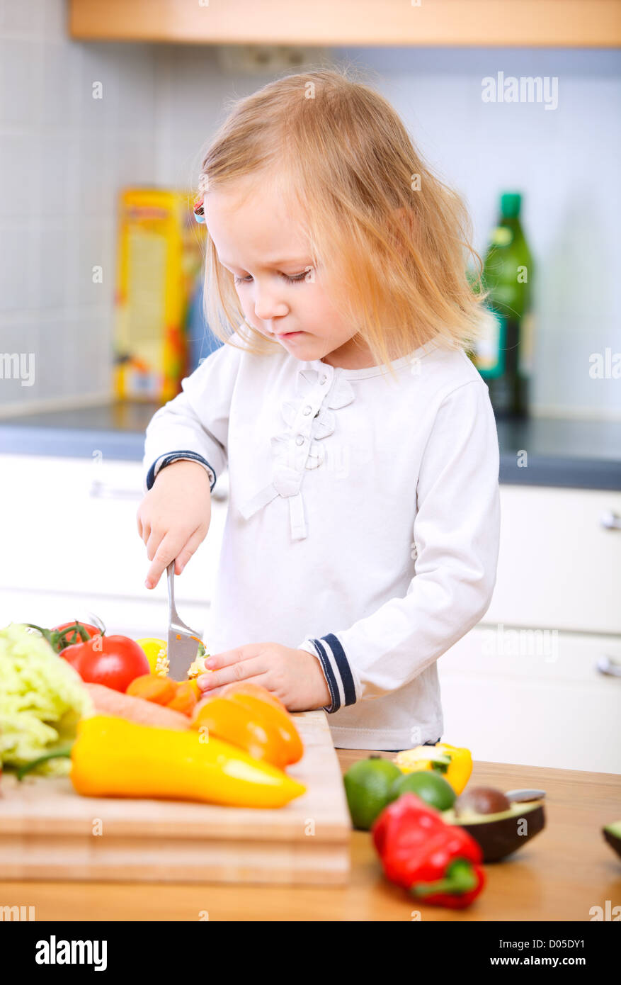 Adorable little girl helping at kitchen Stock Photo - Alamy