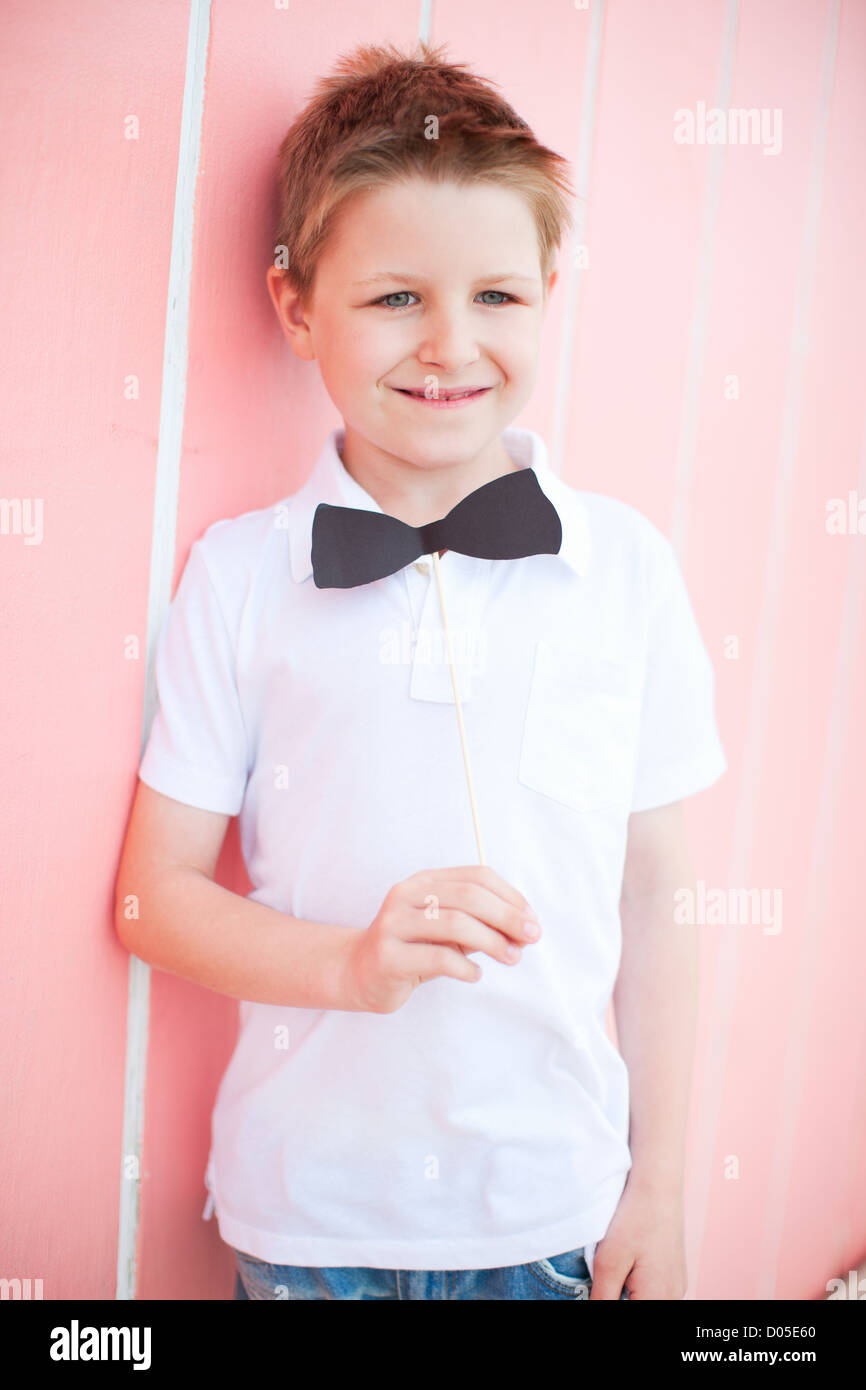 Cute boy with bow tie party accessory Stock Photo - Alamy