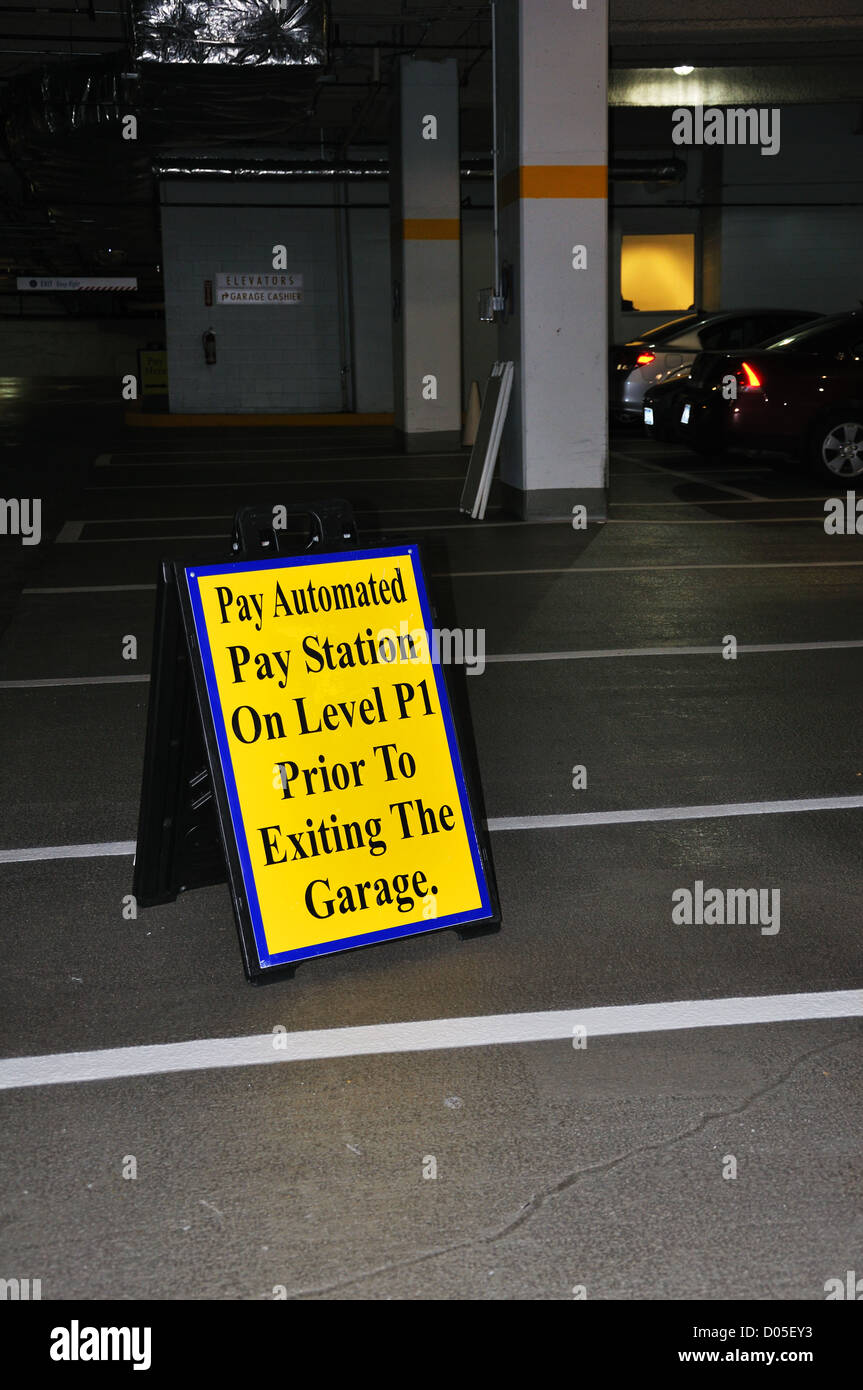 Automated payment sign in a parking garage Stock Photo - Alamy