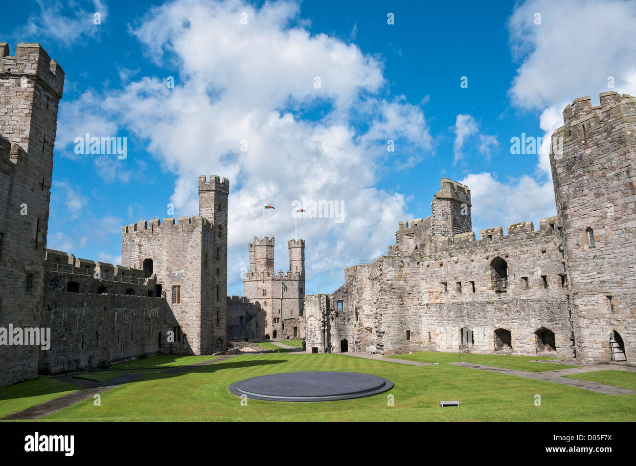 Wales, County Gwynedd, Caernarfon Castle, Welsh flags atop Eagle Tower ...